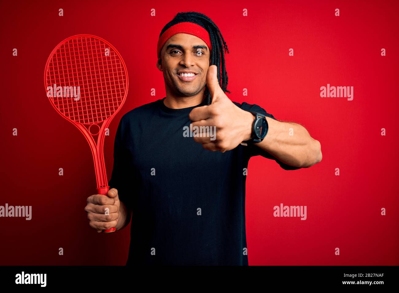 African american afro sportsman with dreadlocks holding tennis racket ...