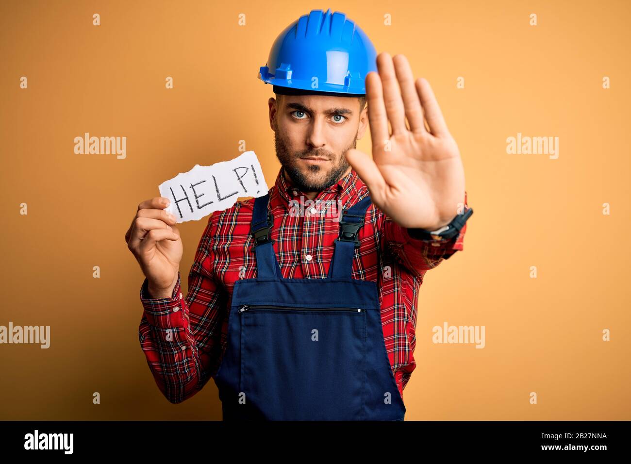 Young builder man wearing safety helmet offering help and support over ...