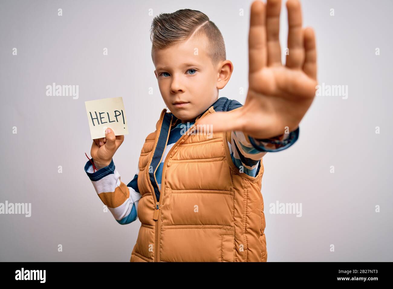 Young little caucasian kid asking for help on a paper note as violence ...