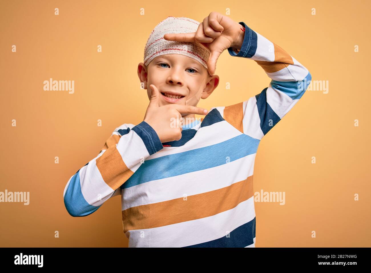 Young little caucasian kid injured wearing medical bandage on head over ...