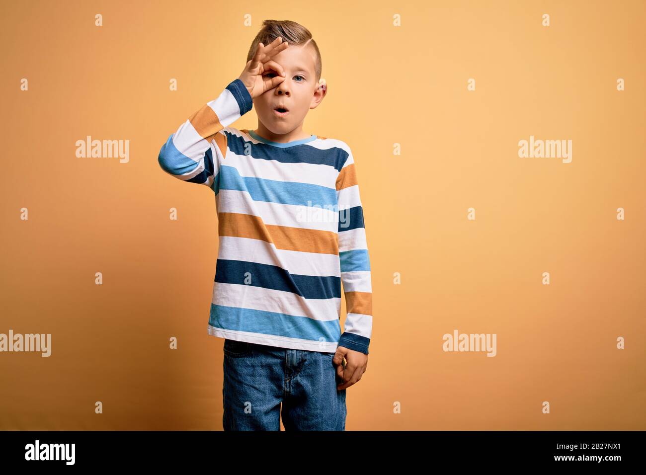 Young little caucasian kid with blue eyes wearing colorful striped ...