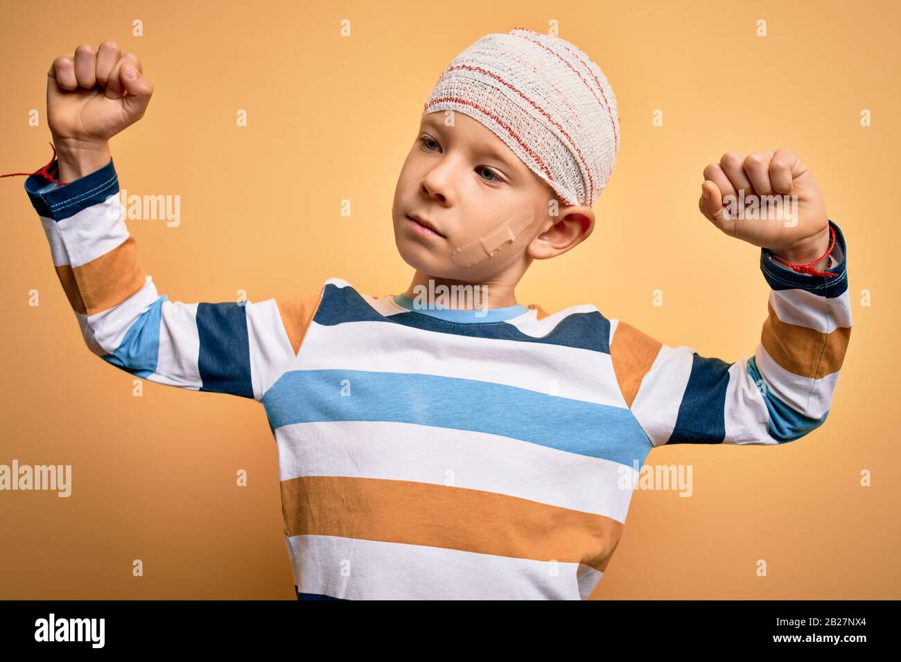 Young little caucasian kid injured wearing medical bandage on head over ...