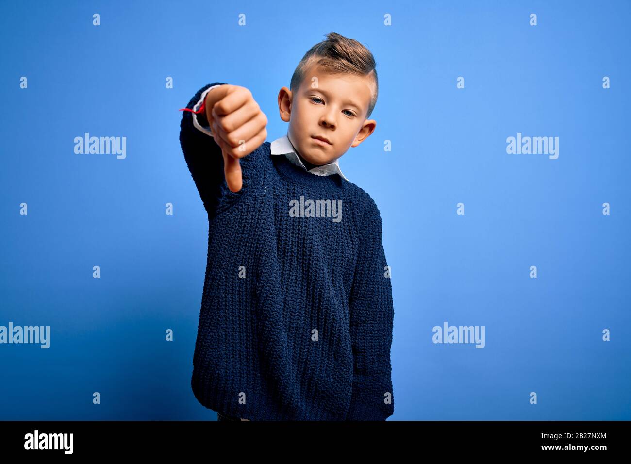 Young little caucasian kid with blue eyes wearing winter sweater over ...