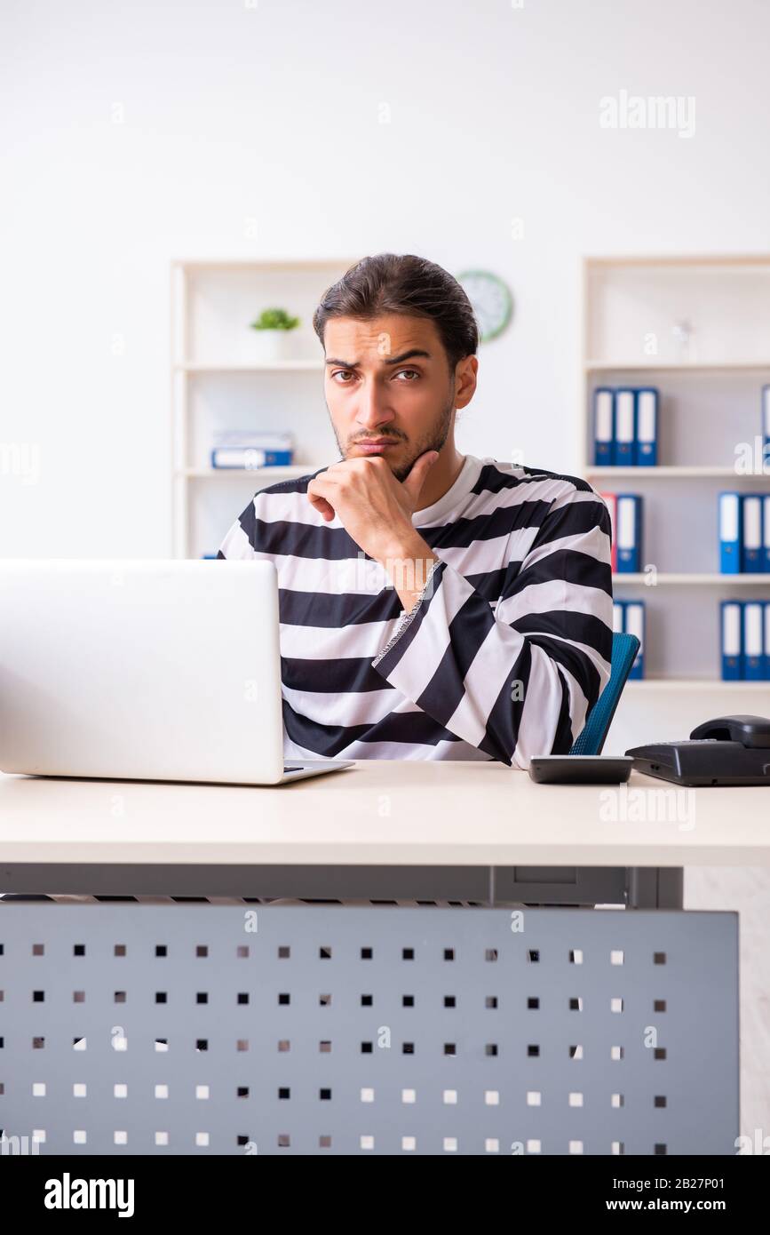 The young employee feeling like prisoner at work Stock Photo - Alamy
