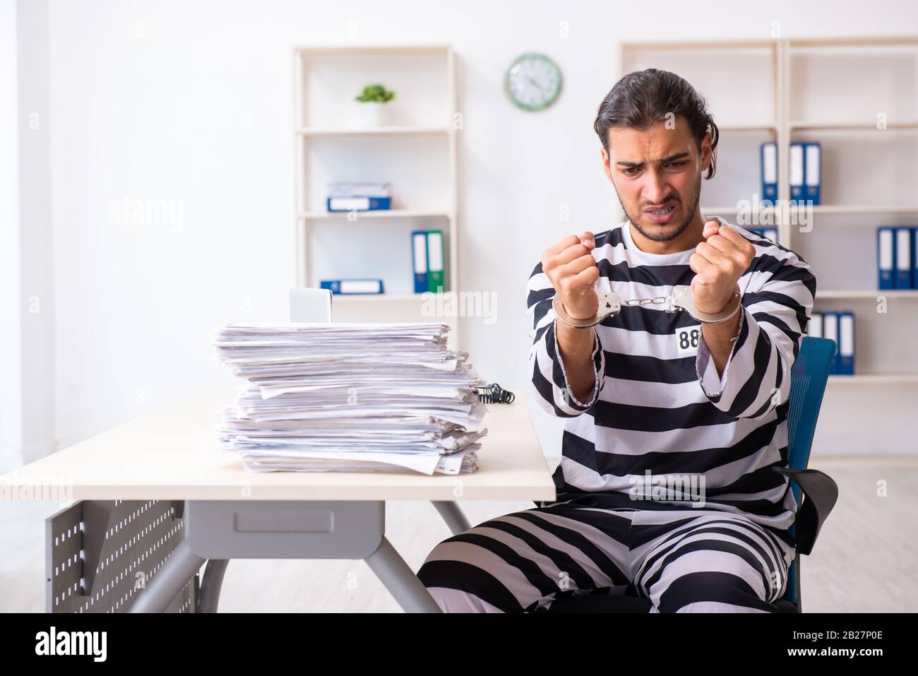 The young employee feeling like prisoner at work Stock Photo - Alamy
