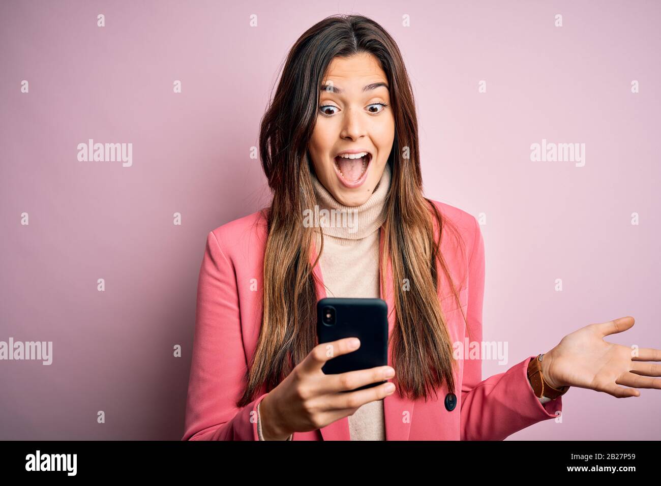 Young beautiful girl having conversation using smartphone over white ...
