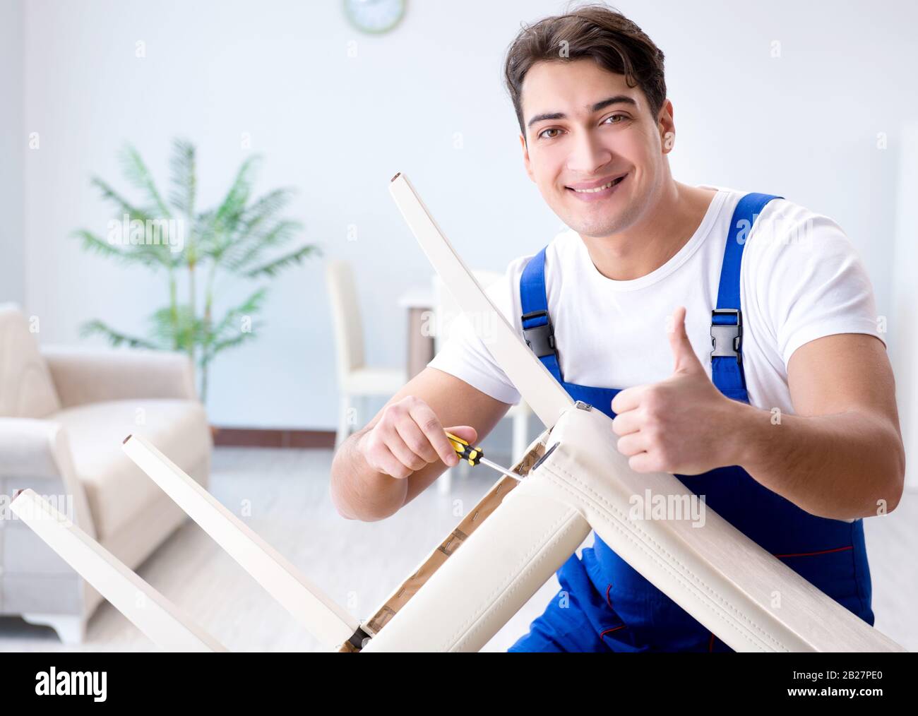 The man repairing chair in the room Stock Photo - Alamy
