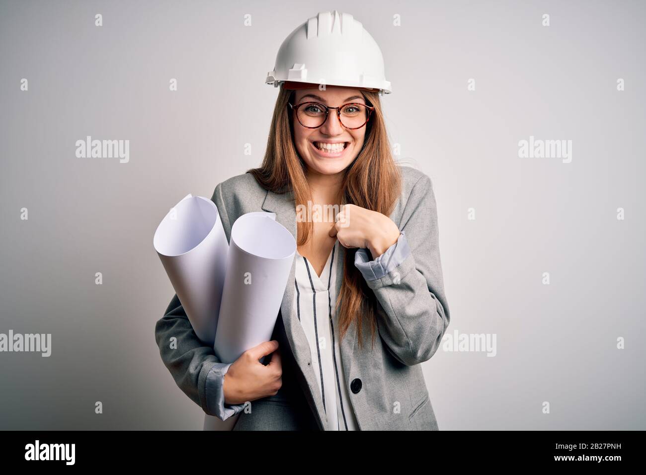 Young beautiful redhead architect woman wearing glasses and safety ... Young beautiful redhead architect woman wearing glasses and safety ...