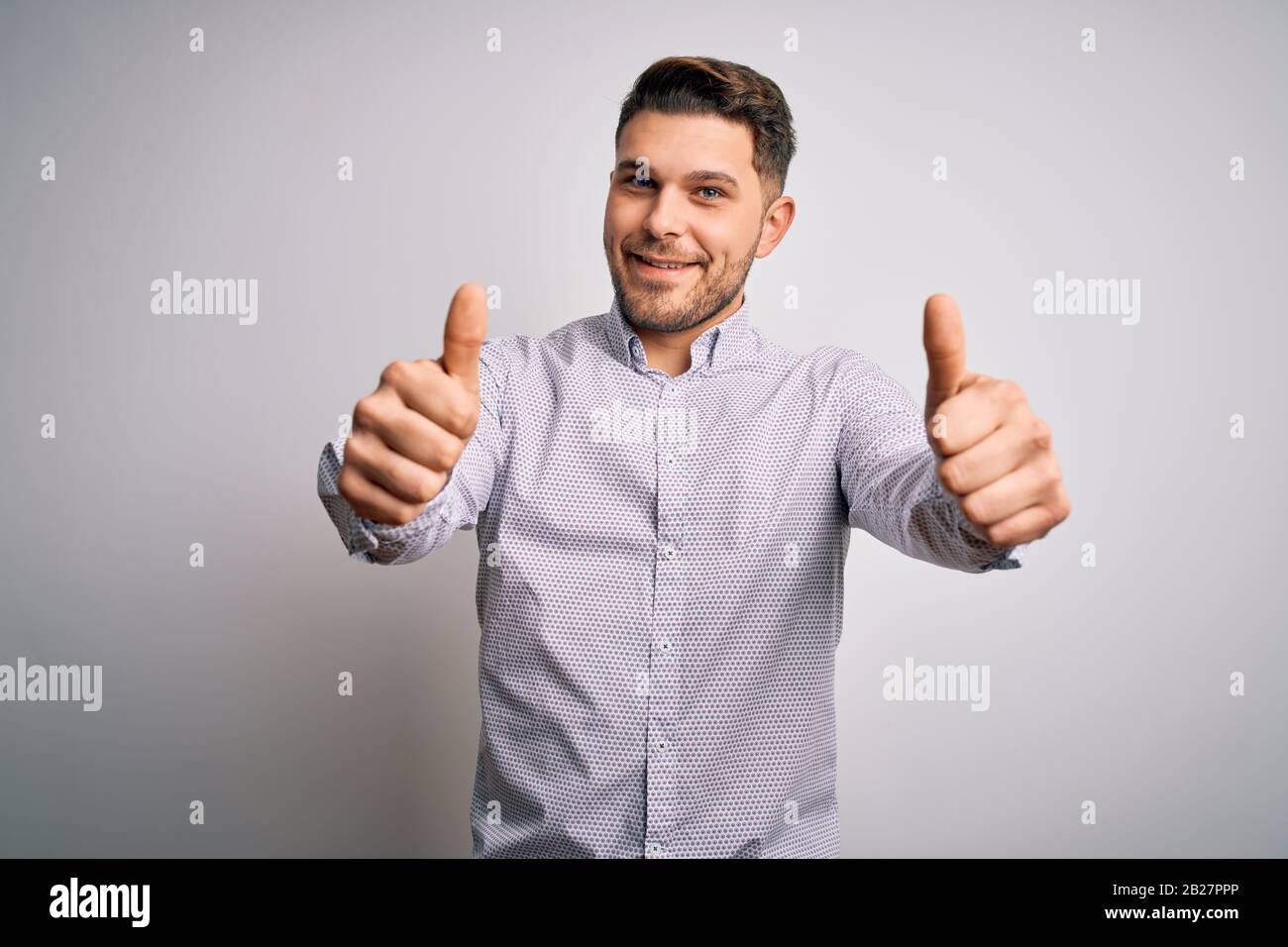 Young business man with blue eyes standing over isolated background ...