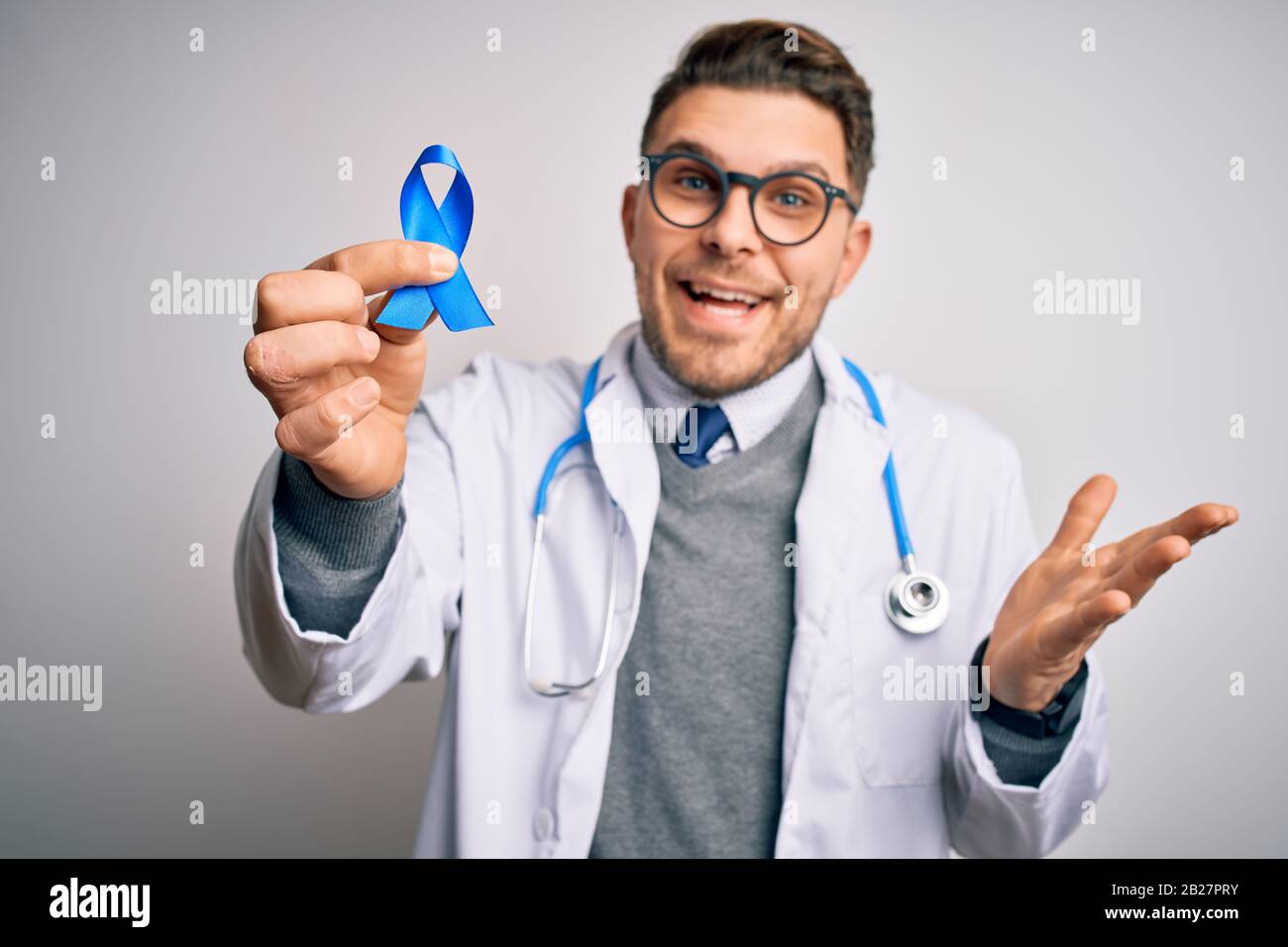 Young doctor man wearing medical coat and holding colon cancer ...
