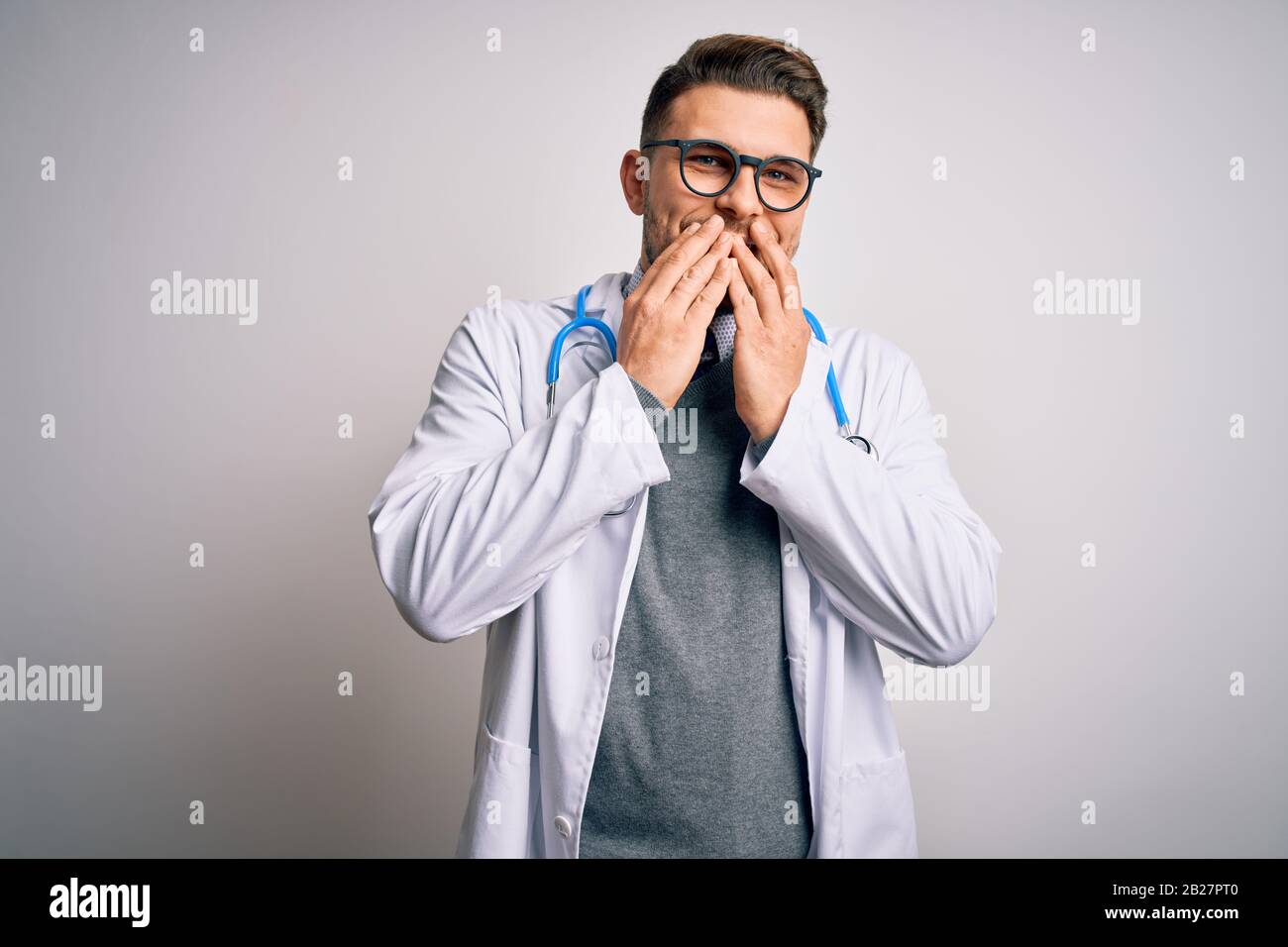 Young doctor man with blue eyes wearing medical coat and stethoscope ...