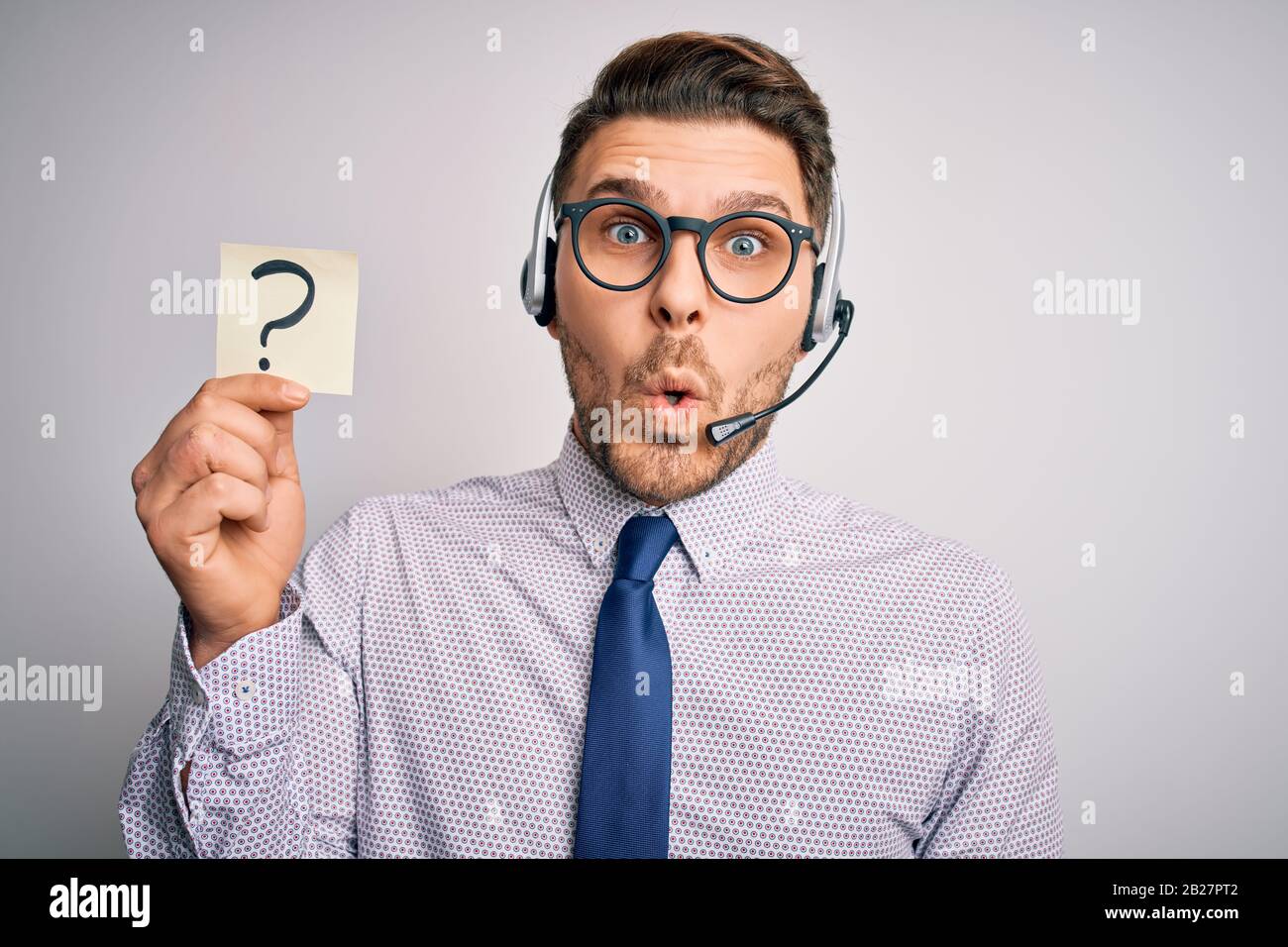 Young call center operator business man with blue eyes holding paper ...