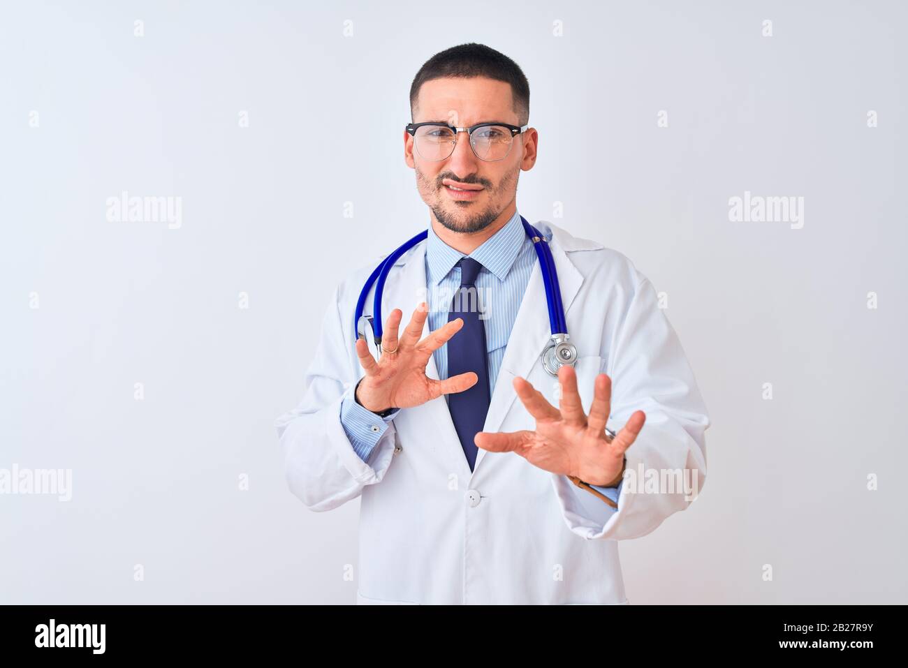 Young doctor man wearing stethoscope over isolated background disgusted ...
