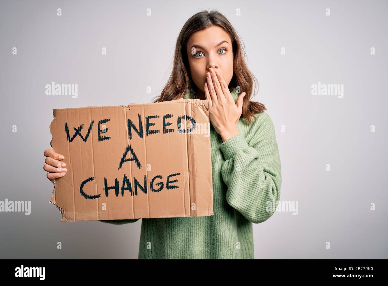 Young blonde girl holding protest banner for political problems and ...