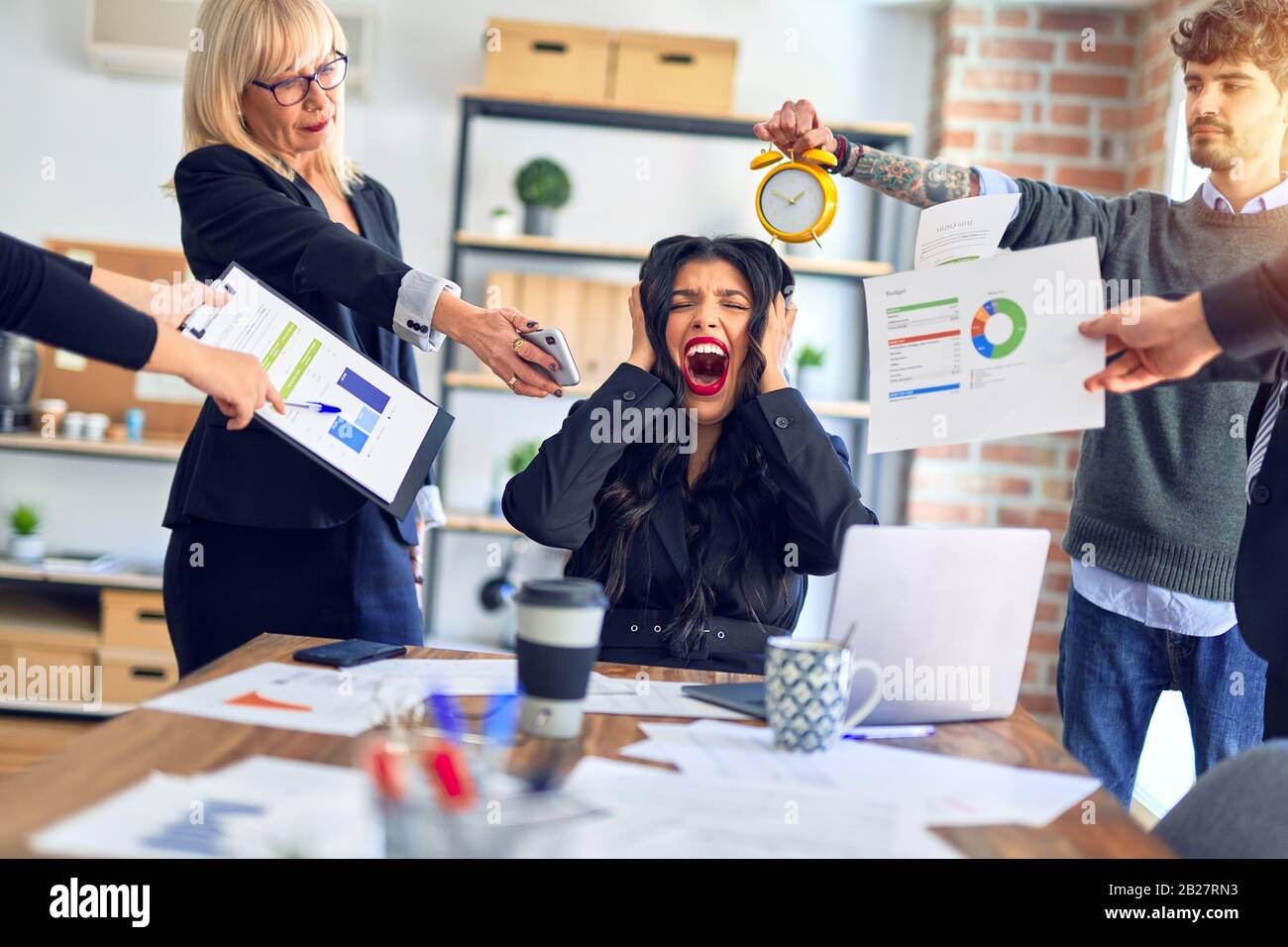 Group of business workers working together. Partners stressing one of ...