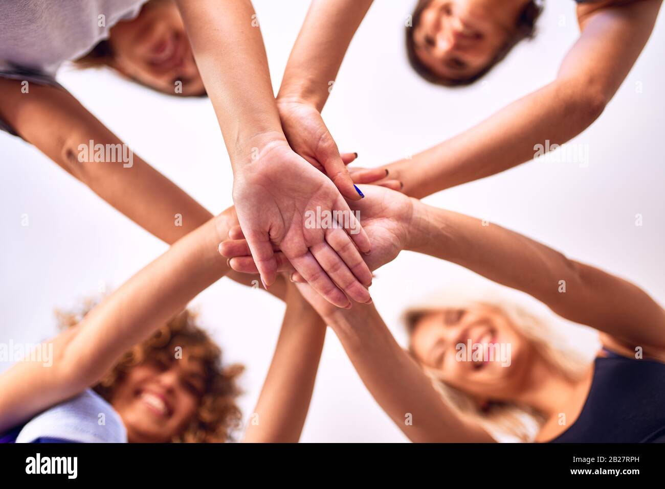 Young beautiful group of sportswomen standing shaking hands after class ...