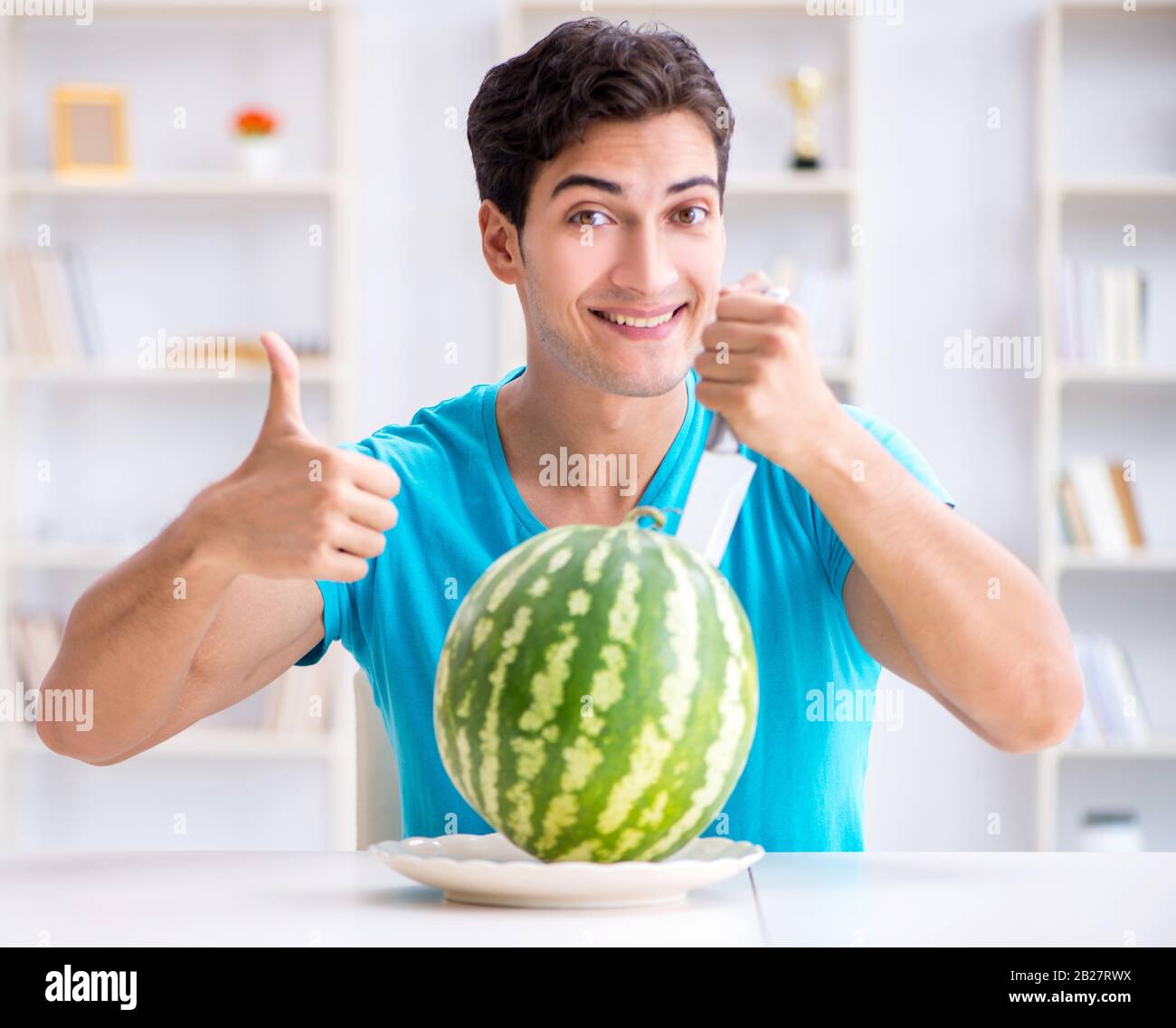 The man eating watermelon at home Stock Photo - Alamy