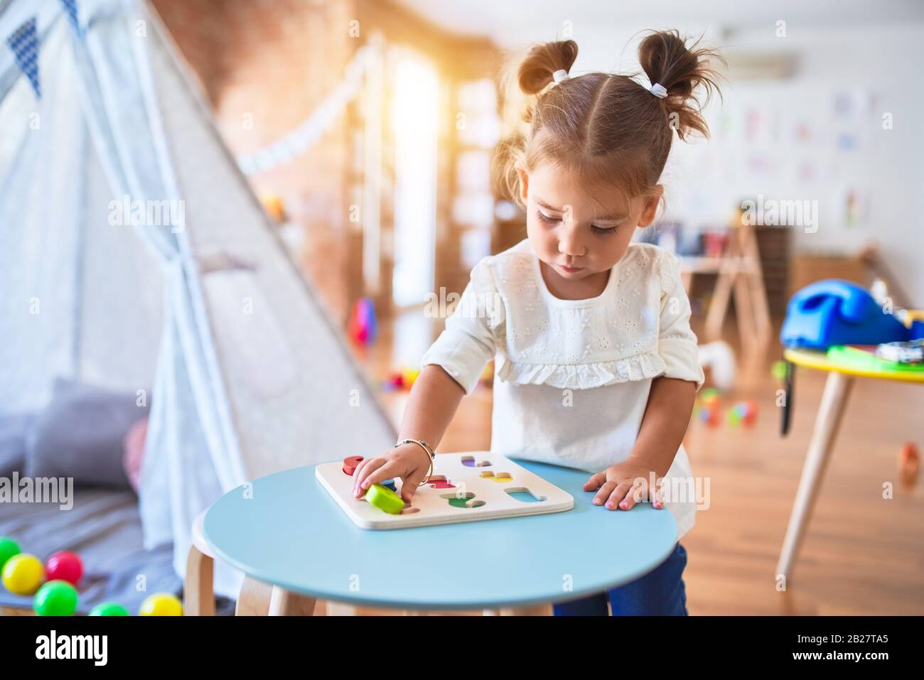 Young beautiful toddler learning mathematics playing with maths game at ...