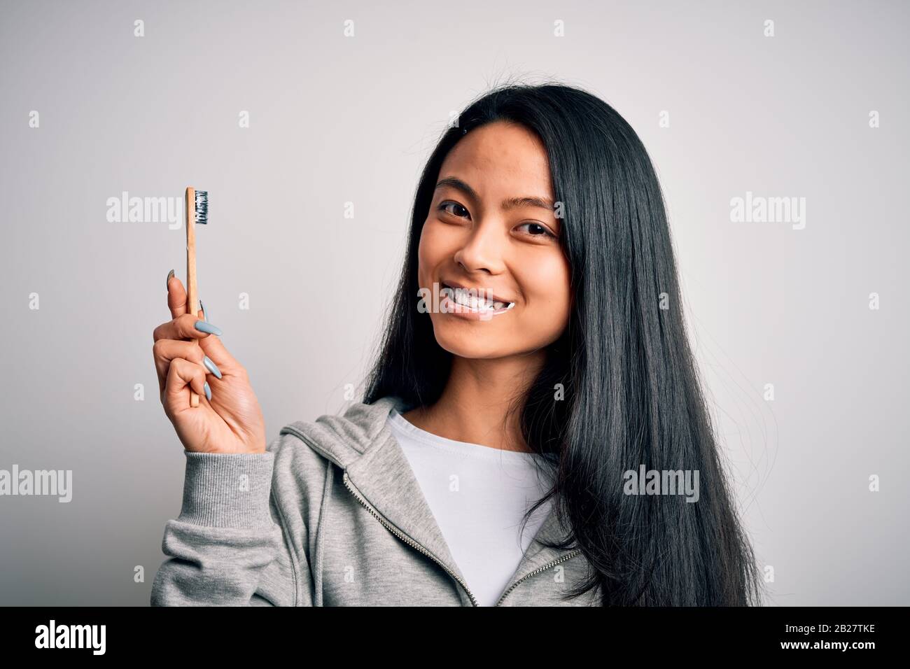 Young beautiful woman smiling happy. Standing with smile on face ...