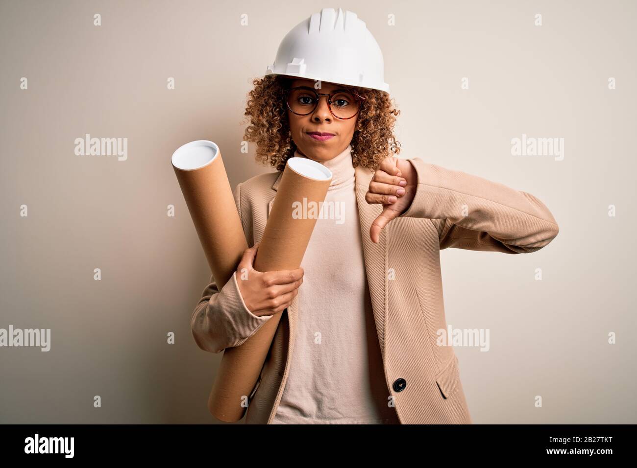 African american curly architect woman wearing safety helmet and ...
