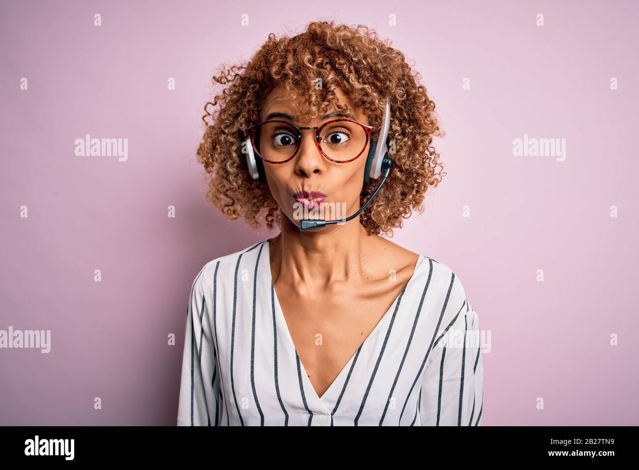 African american curly call center agent woman working using headset ...