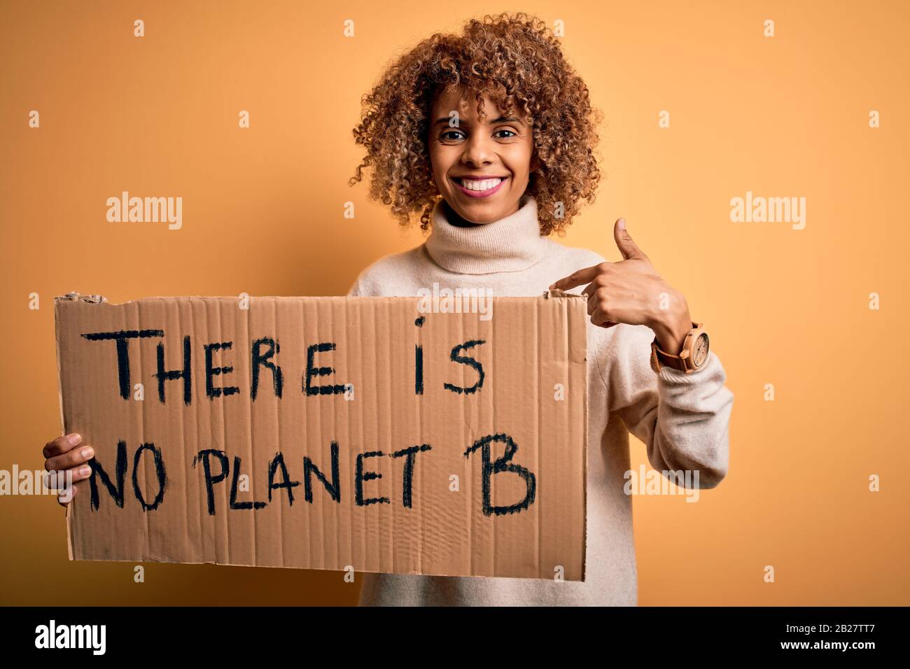 African american activist woman asking for environment holding banner ...