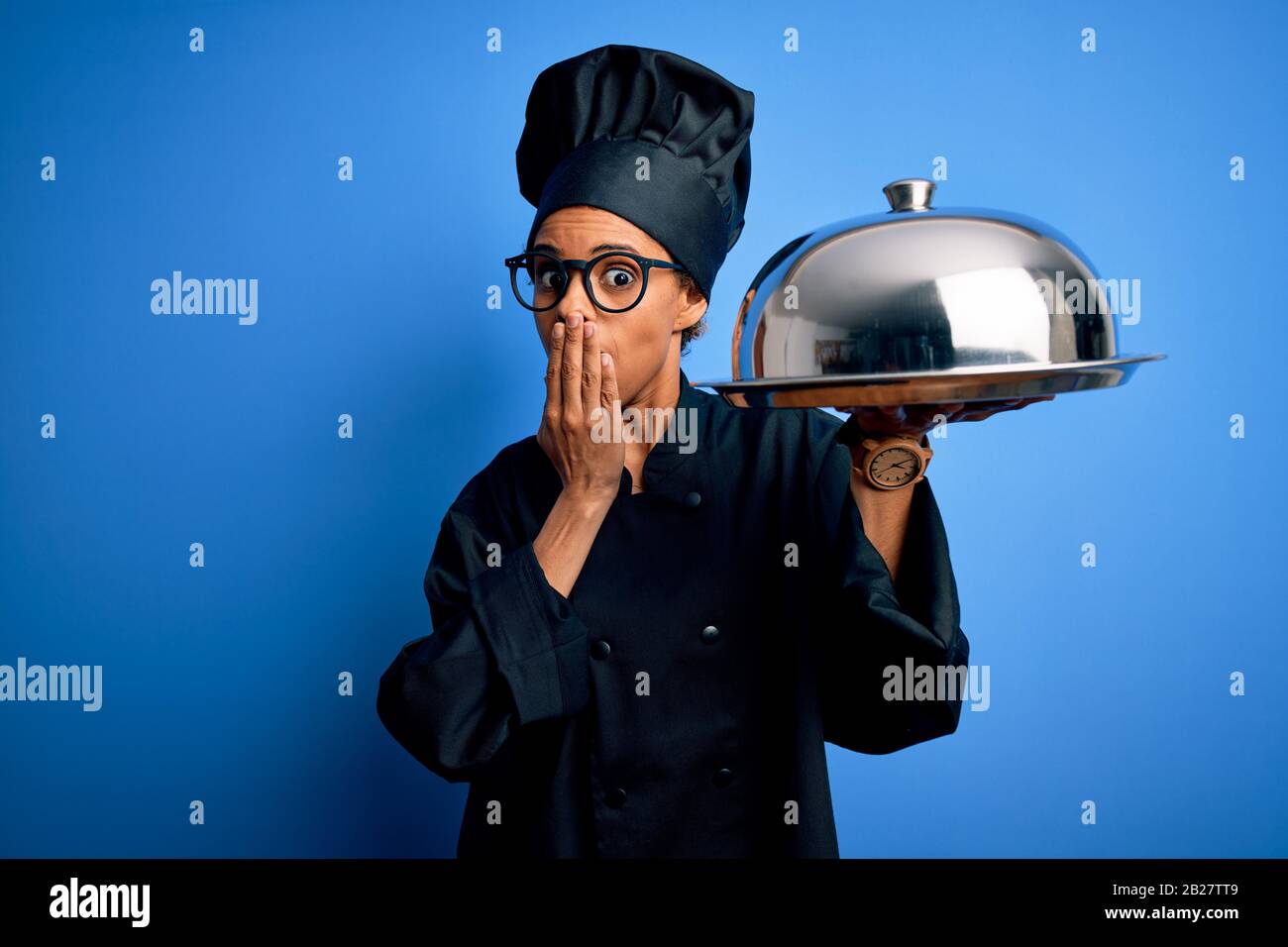 Young african american cooker woman wearing uniform holding waiter tray ...