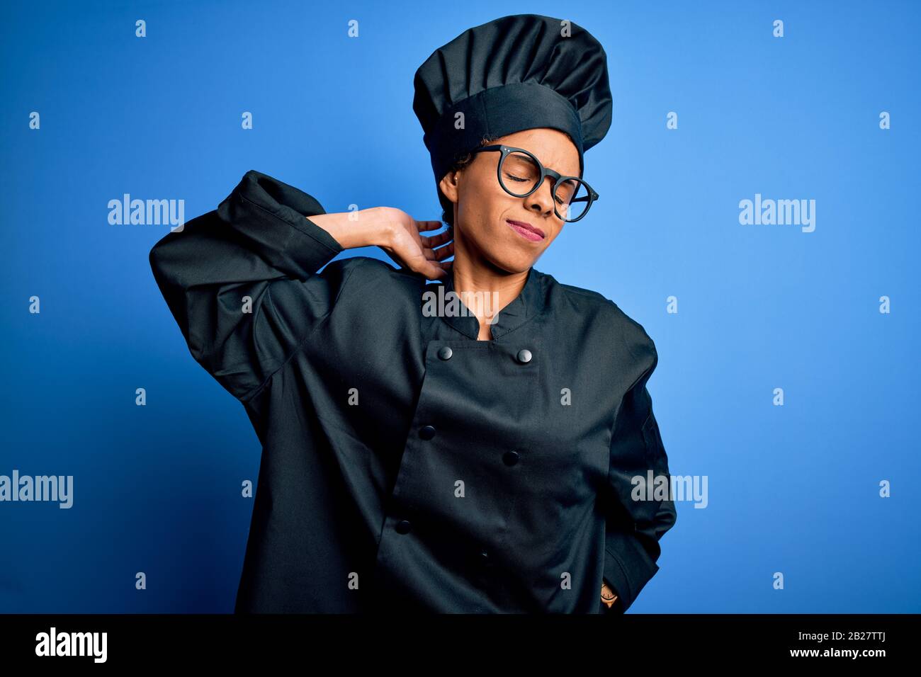 Young african american chef woman wearing cooker uniform and hat over ...