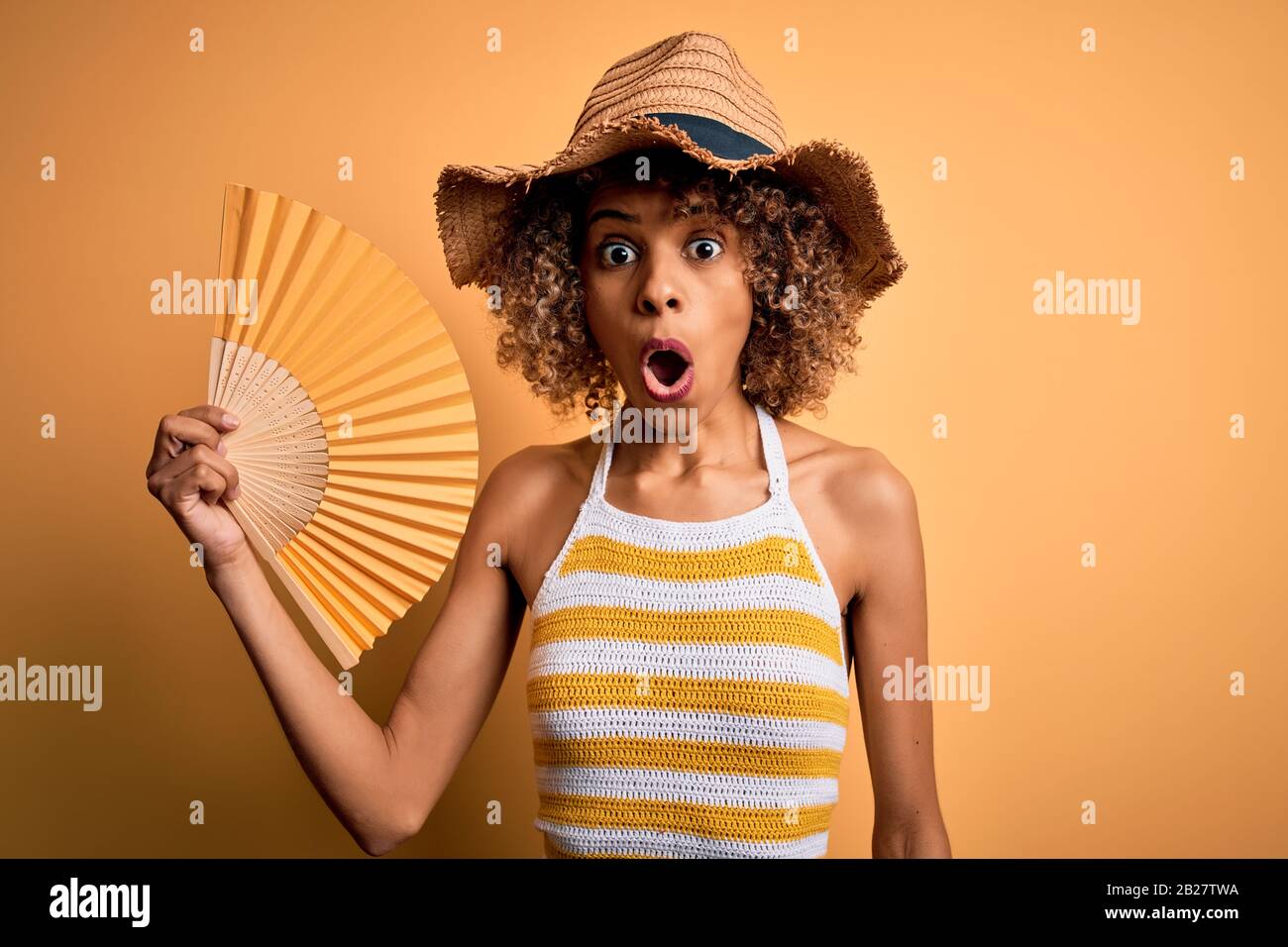 African american tourist woman with curly on vacation wearing summer ...