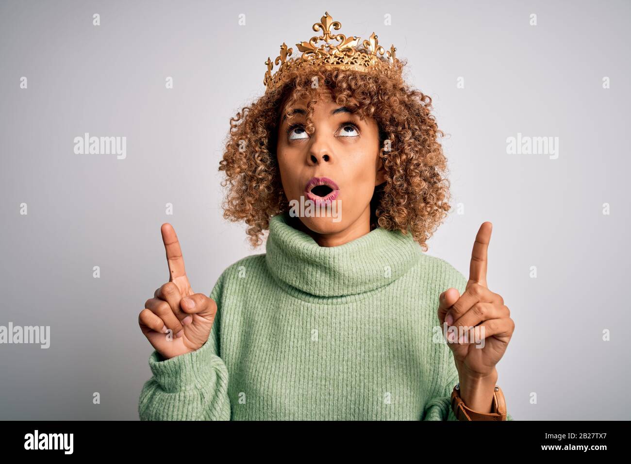 Young african american woman wearing golden crown of queen over ...
