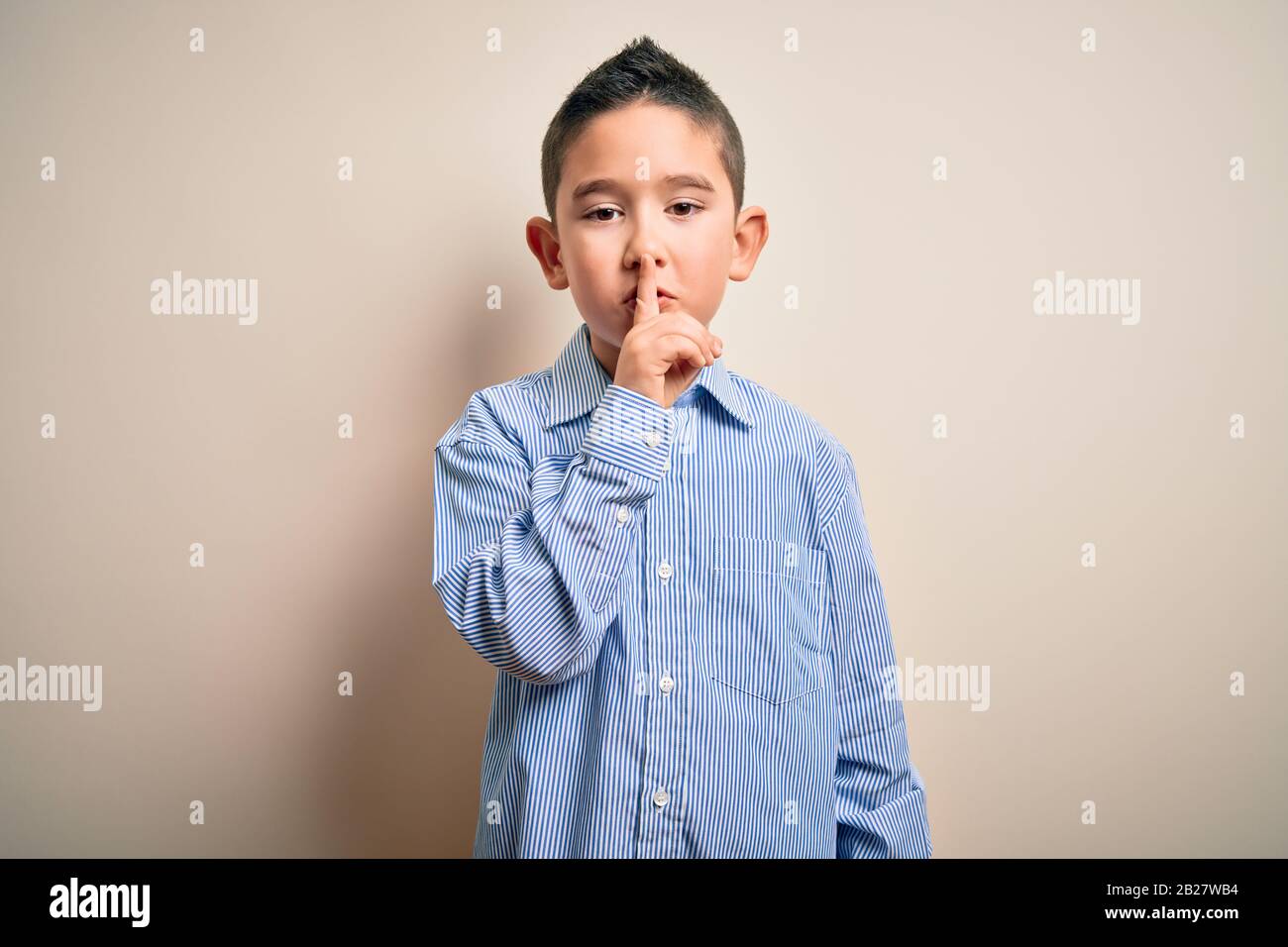 Young little boy kid wearing elegant shirt standing over isolated ...