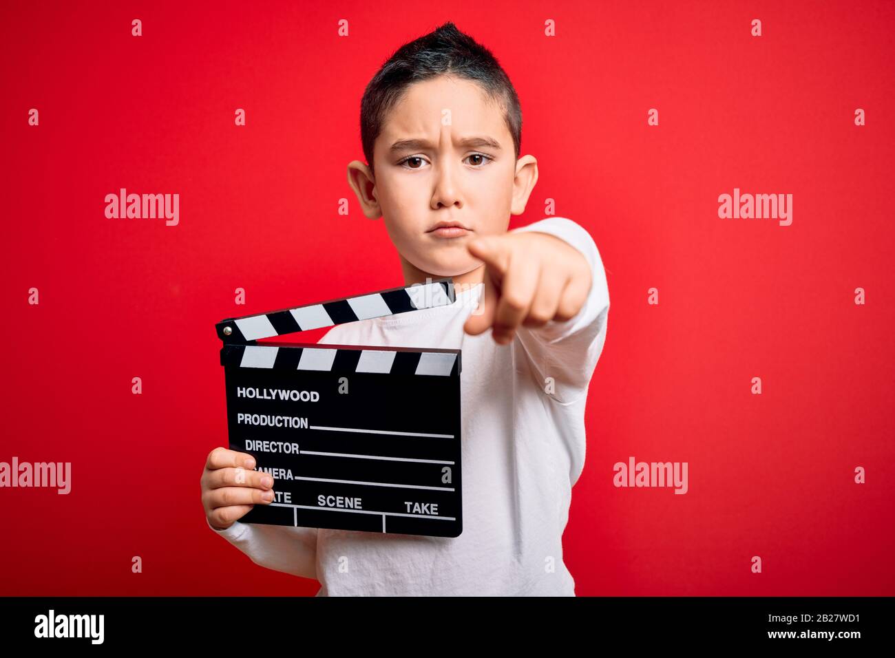 Young little boy kid filming video holding cinema director clapboard ...