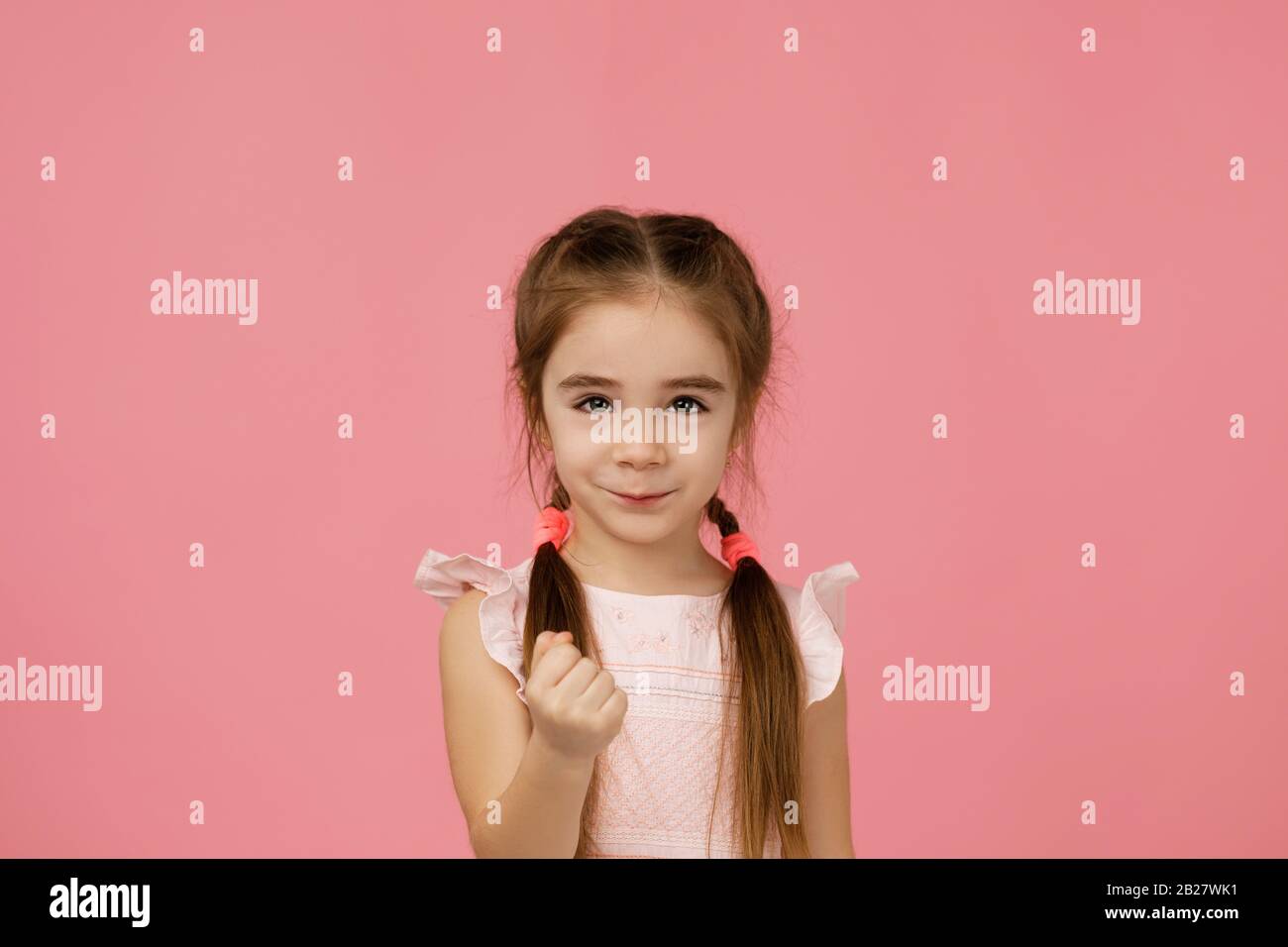 angry little child girl in dress raising fist frustrated and furious ...