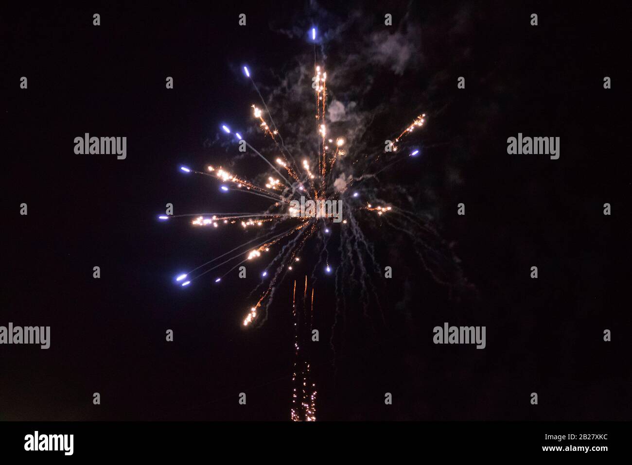 Small, single, fireworks in a black, night sky. Small, single ...