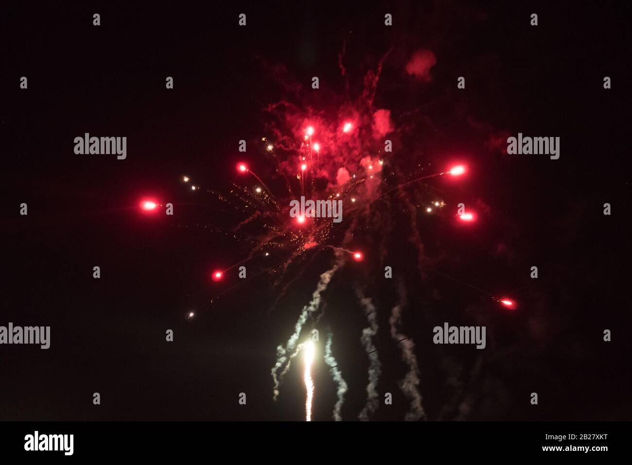 Small, single, fireworks in a black, night sky. Small, single ...