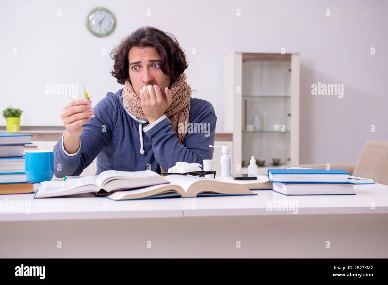The sick male student suffering at home Stock Photo - Alamy