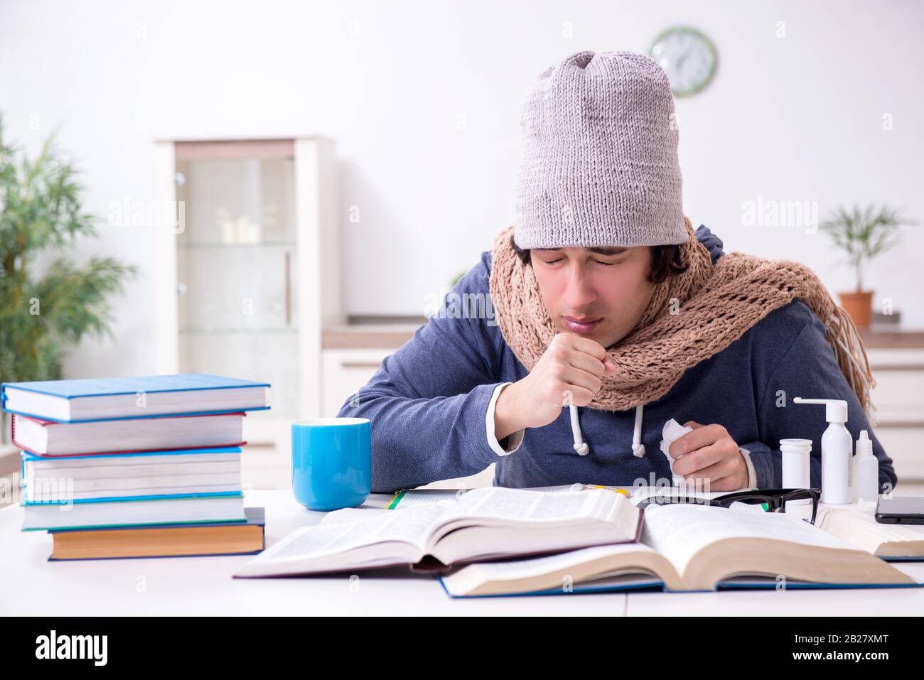 The sick male student suffering at home Stock Photo - Alamy