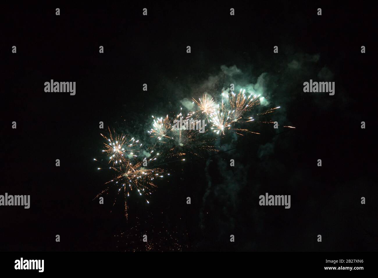 Small, single, fireworks in a black, night sky. Small, single ...