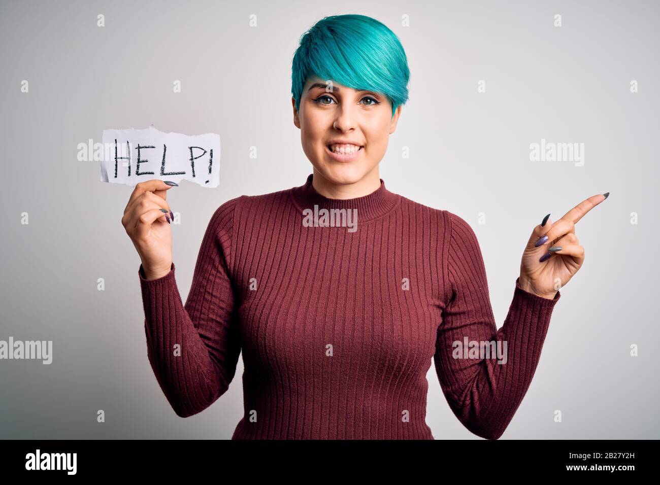Young woman with blue fashion hair asking for help showing message on ...