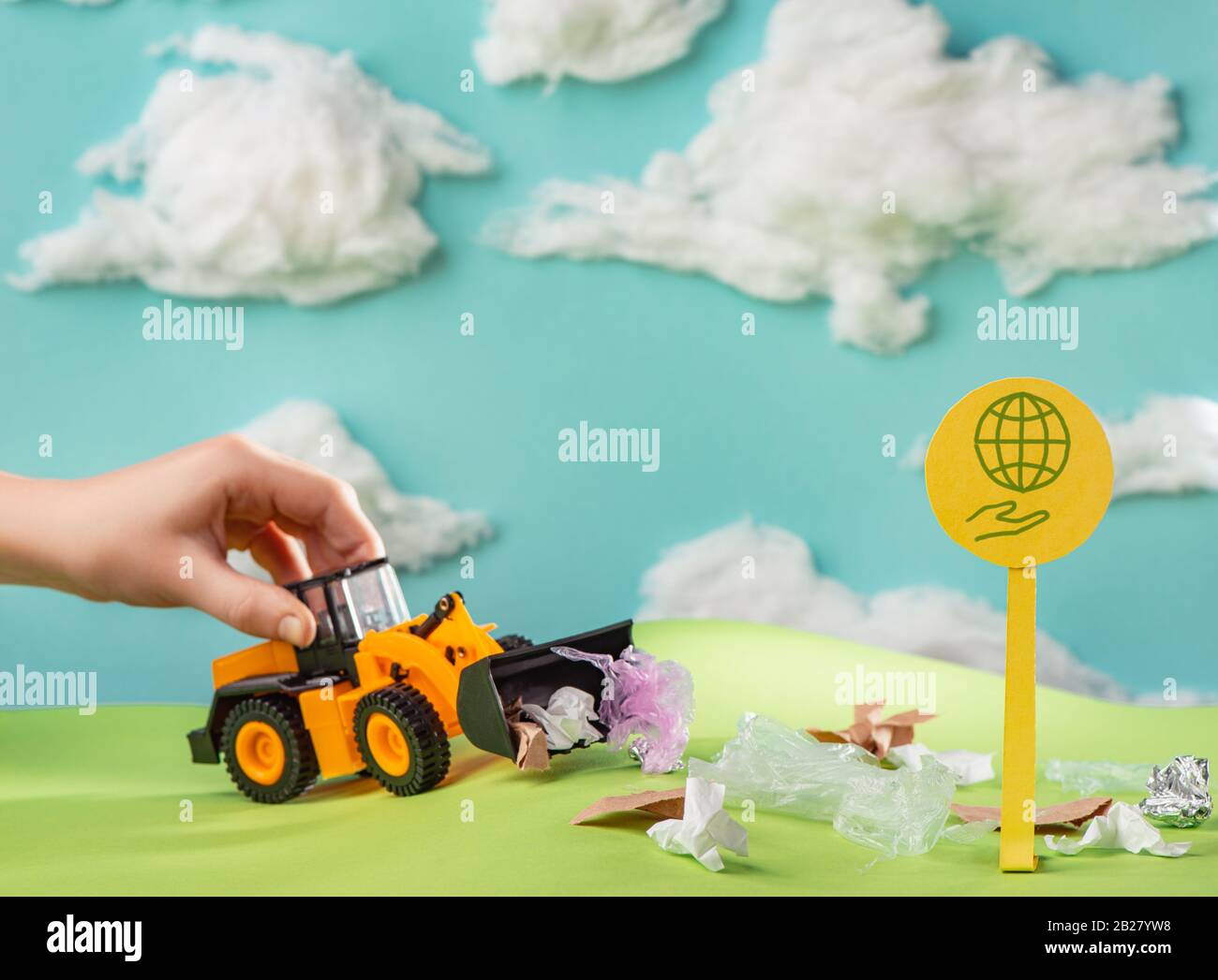 Child playing with a truck collecting garbage on the lawn Stock Photo ...