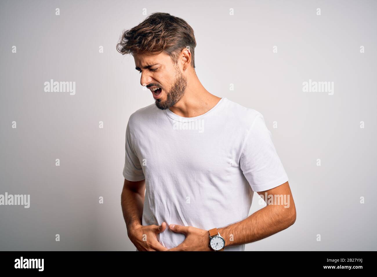 Young handsome man with beard wearing casual t-shirt standing over ...