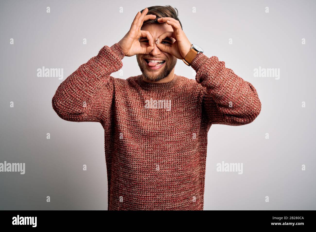 Young blond man with beard and blue eyes wearing casual sweater over ...