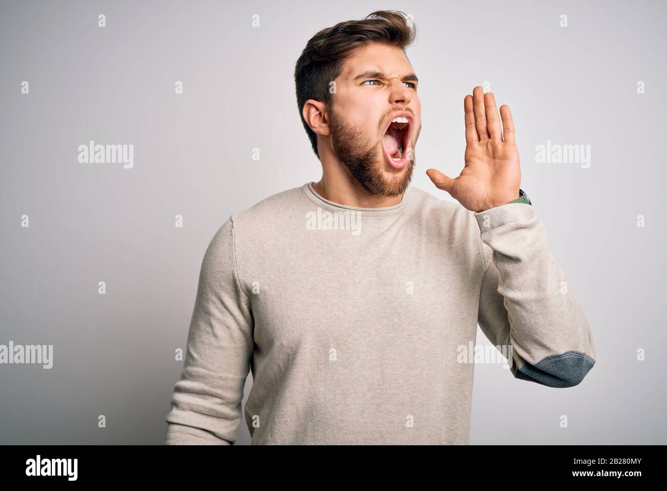 Young handsome blond man with beard and blue eyes wearing casual ...