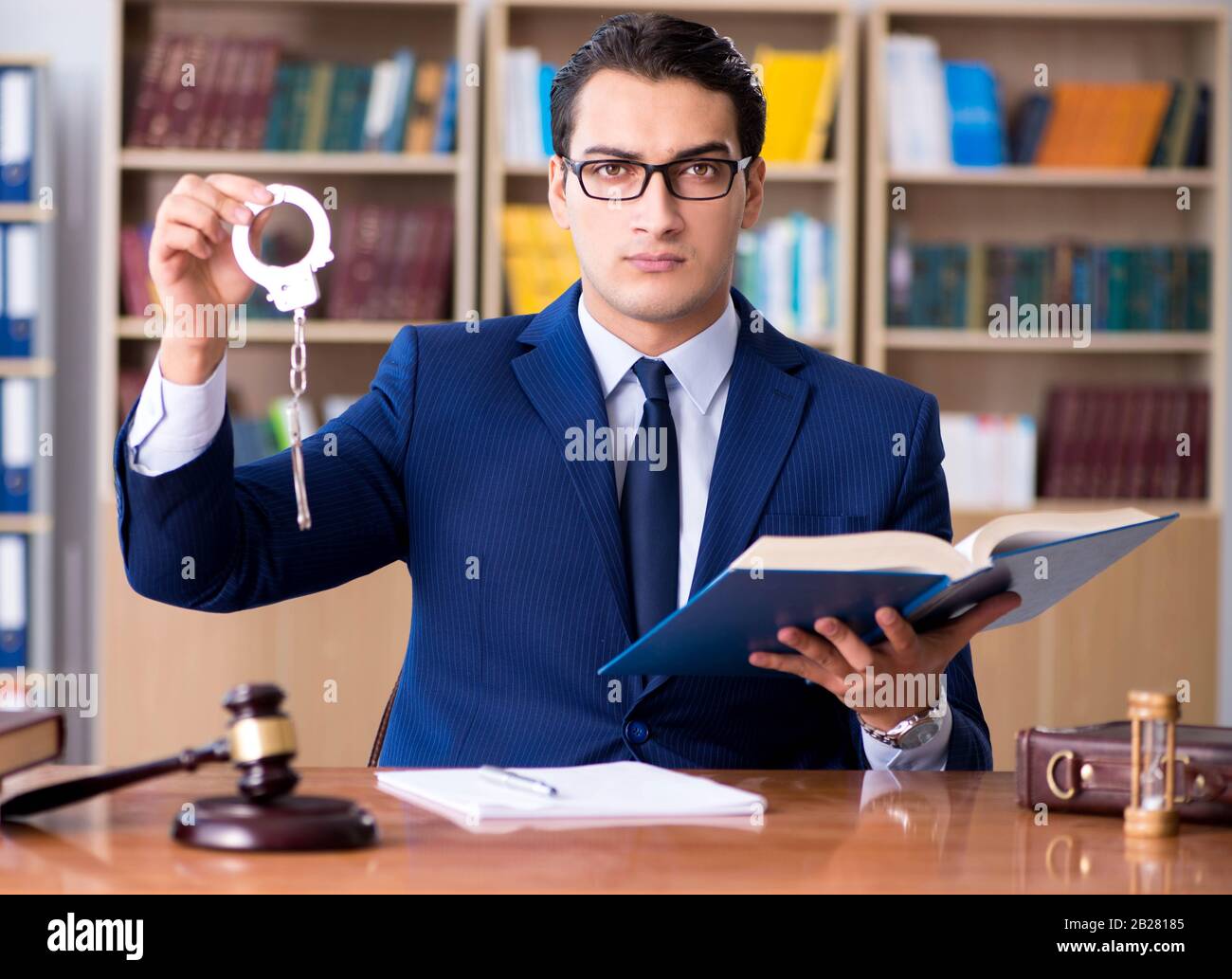 The handsome judge with gavel sitting in courtroom Stock Photo - Alamy