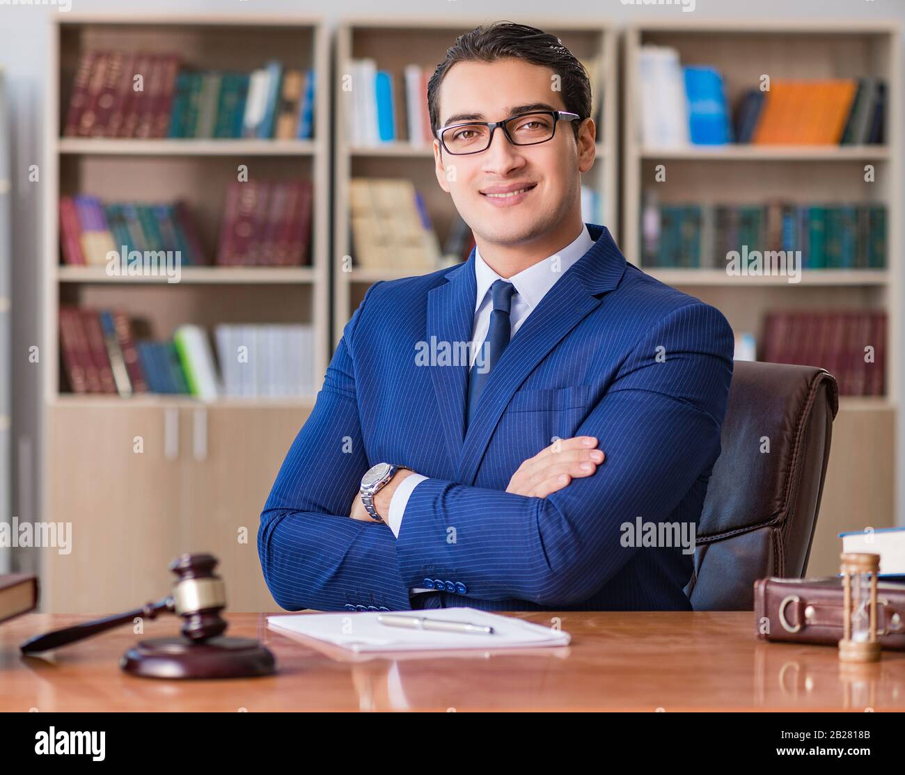 The handsome judge with gavel sitting in courtroom Stock Photo - Alamy