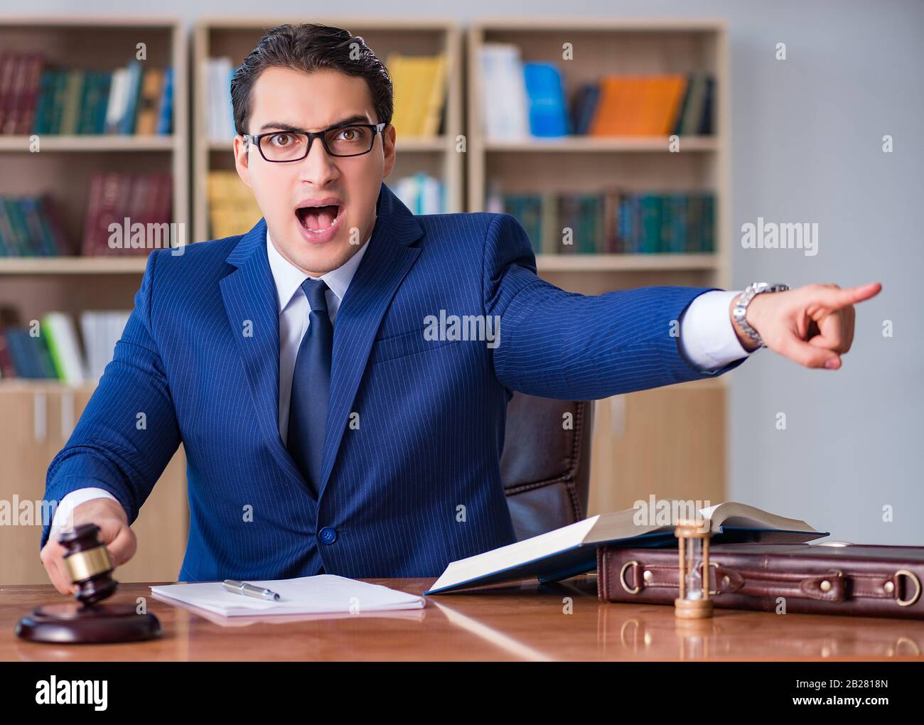 The handsome judge with gavel sitting in courtroom Stock Photo - Alamy