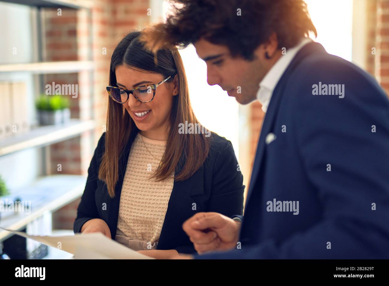 Two young beautiful business workers smiling happy and confident ...