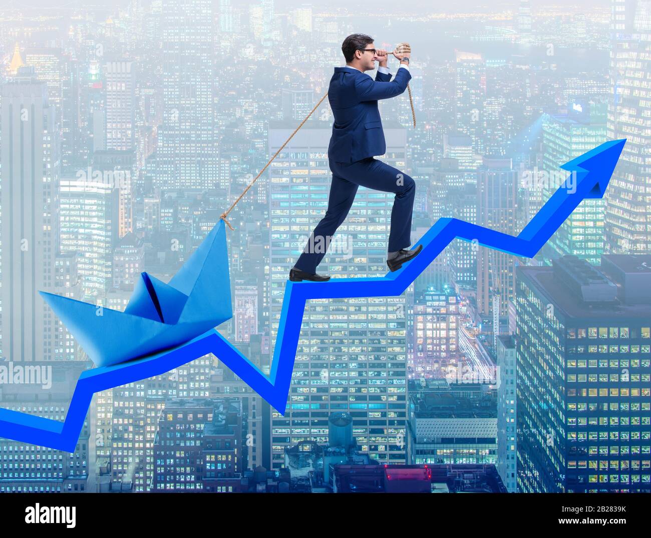The businessman pulling boat over line chart Stock Photo - Alamy