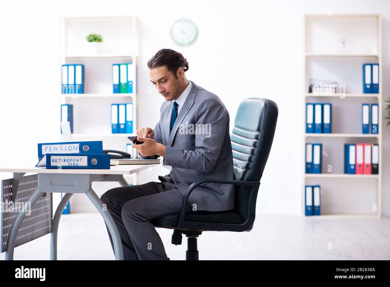The young male accountant working in the office Stock Photo - Alamy