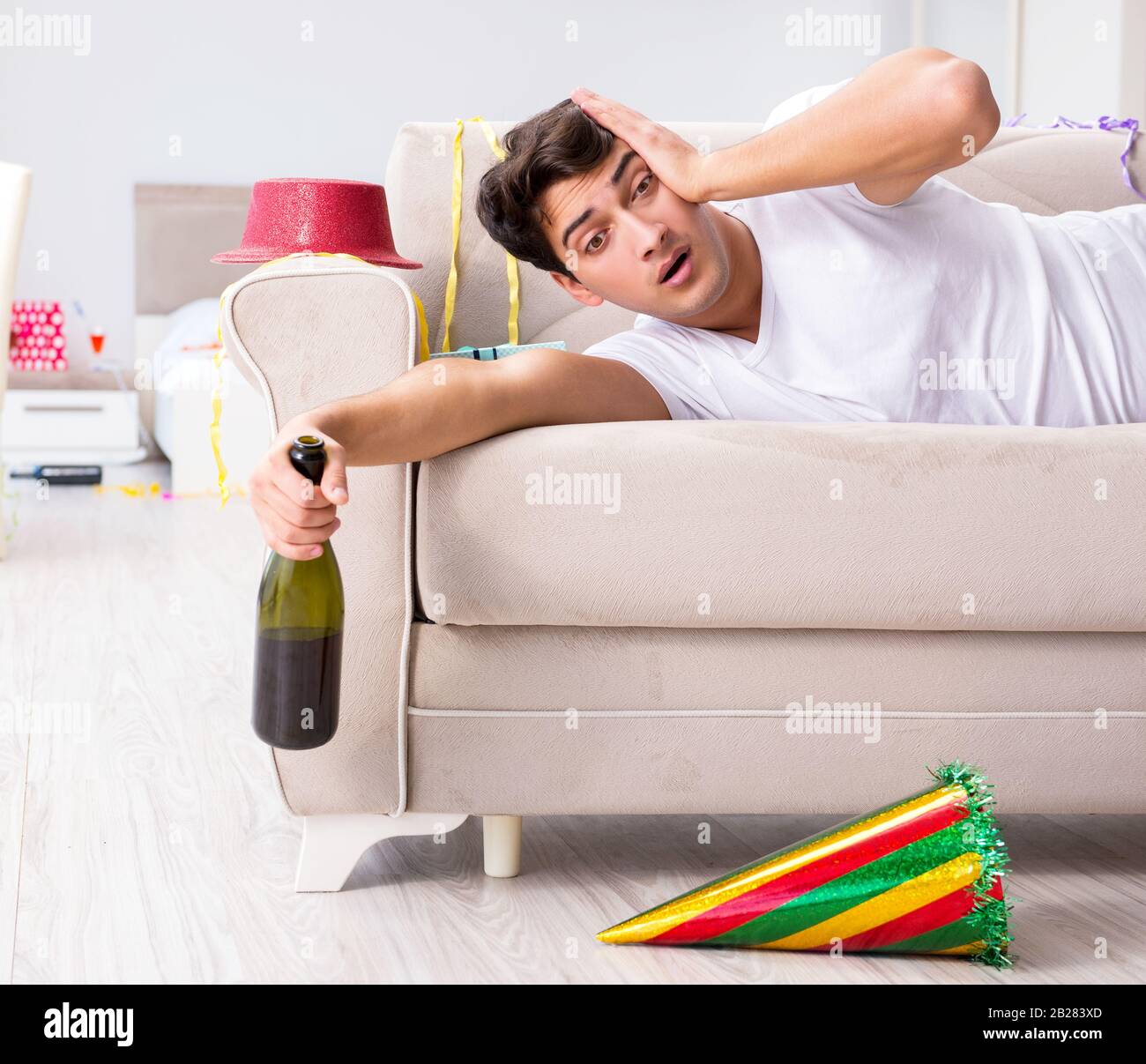 The man at home after heavy partying Stock Photo - Alamy